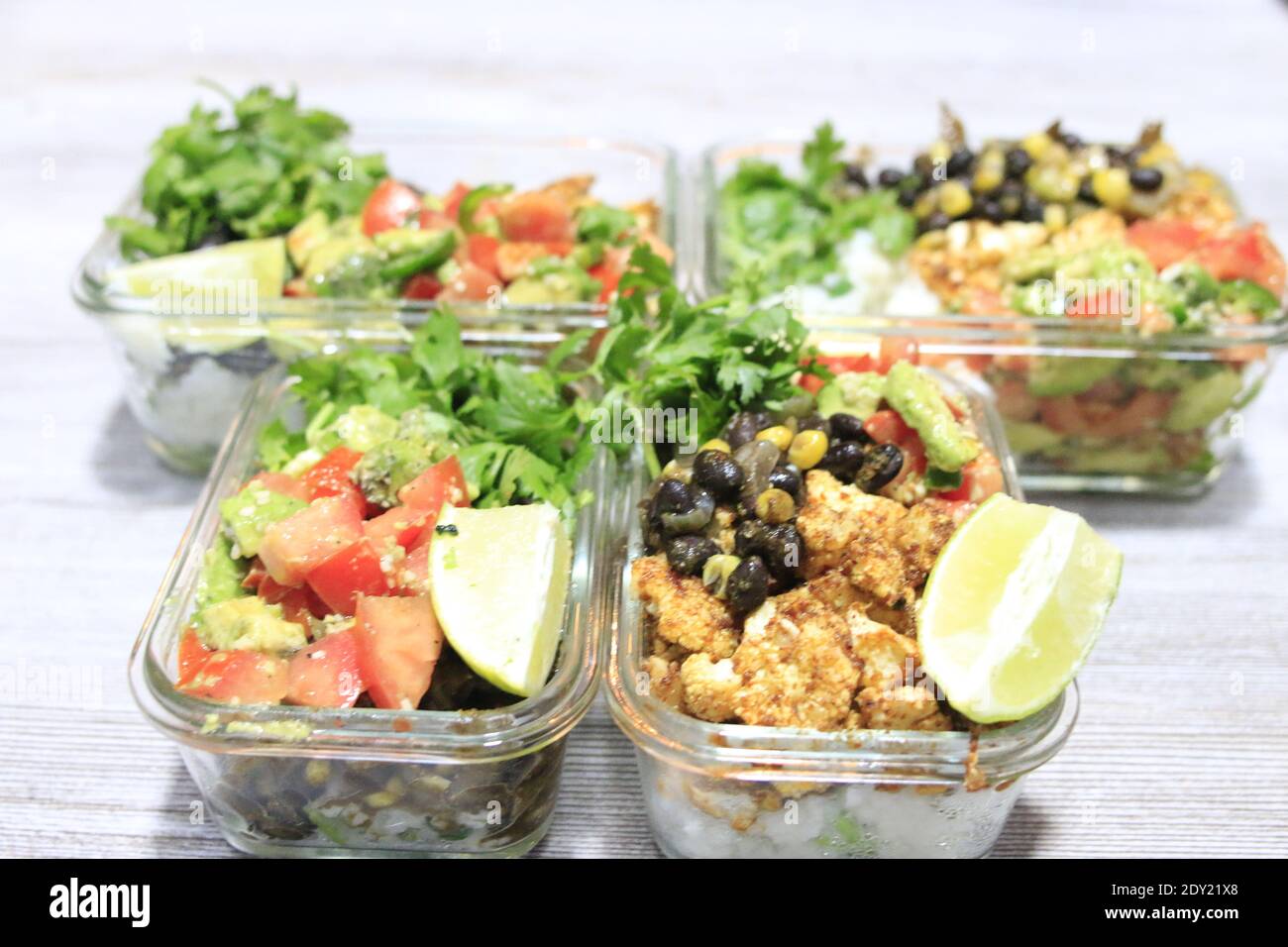 meal prep in glass lunch boxes of burrito bowls Stock Photo - Alamy