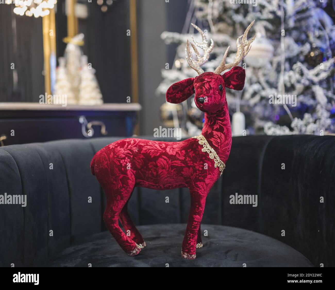 A red Christmas deer with floral pattern and golden details Stock Photo ...