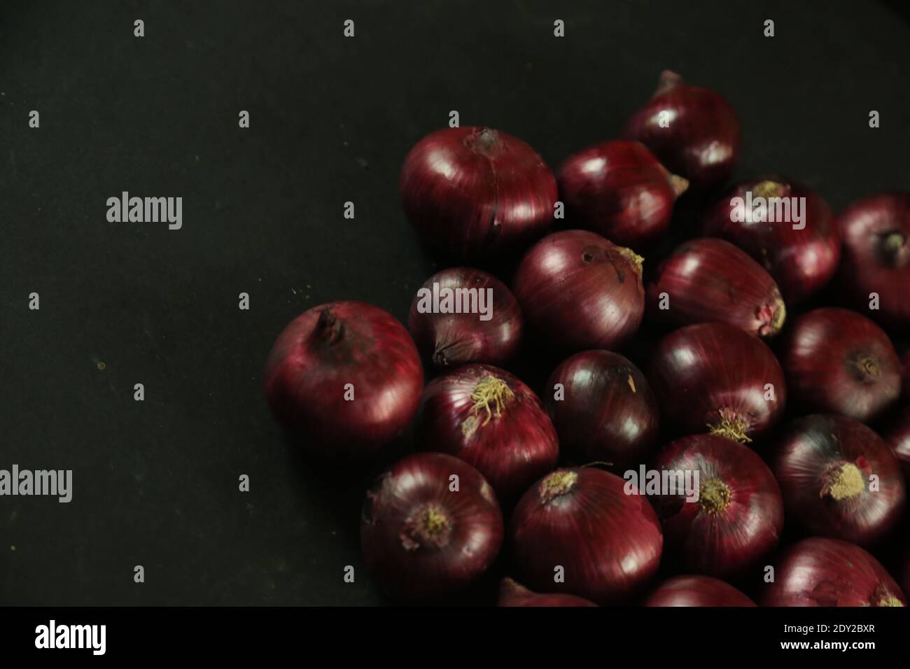 sweet red onions on background Stock Photo - Alamy