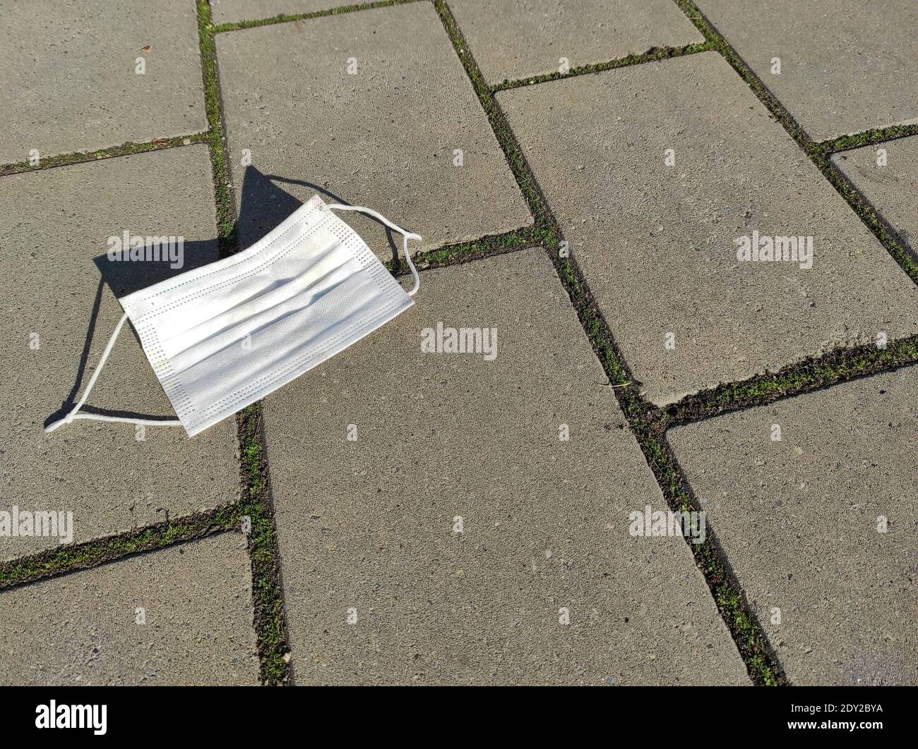 A high angle shot of a medical mask on the ground - pandemic concept ...