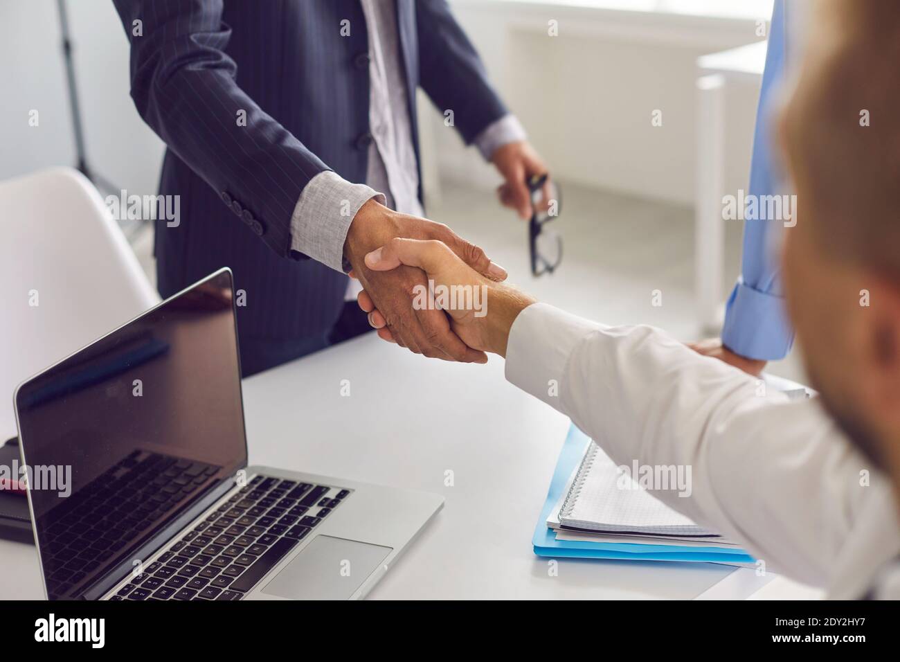 Business partners shaking hands, confirming collaboration and financial ...