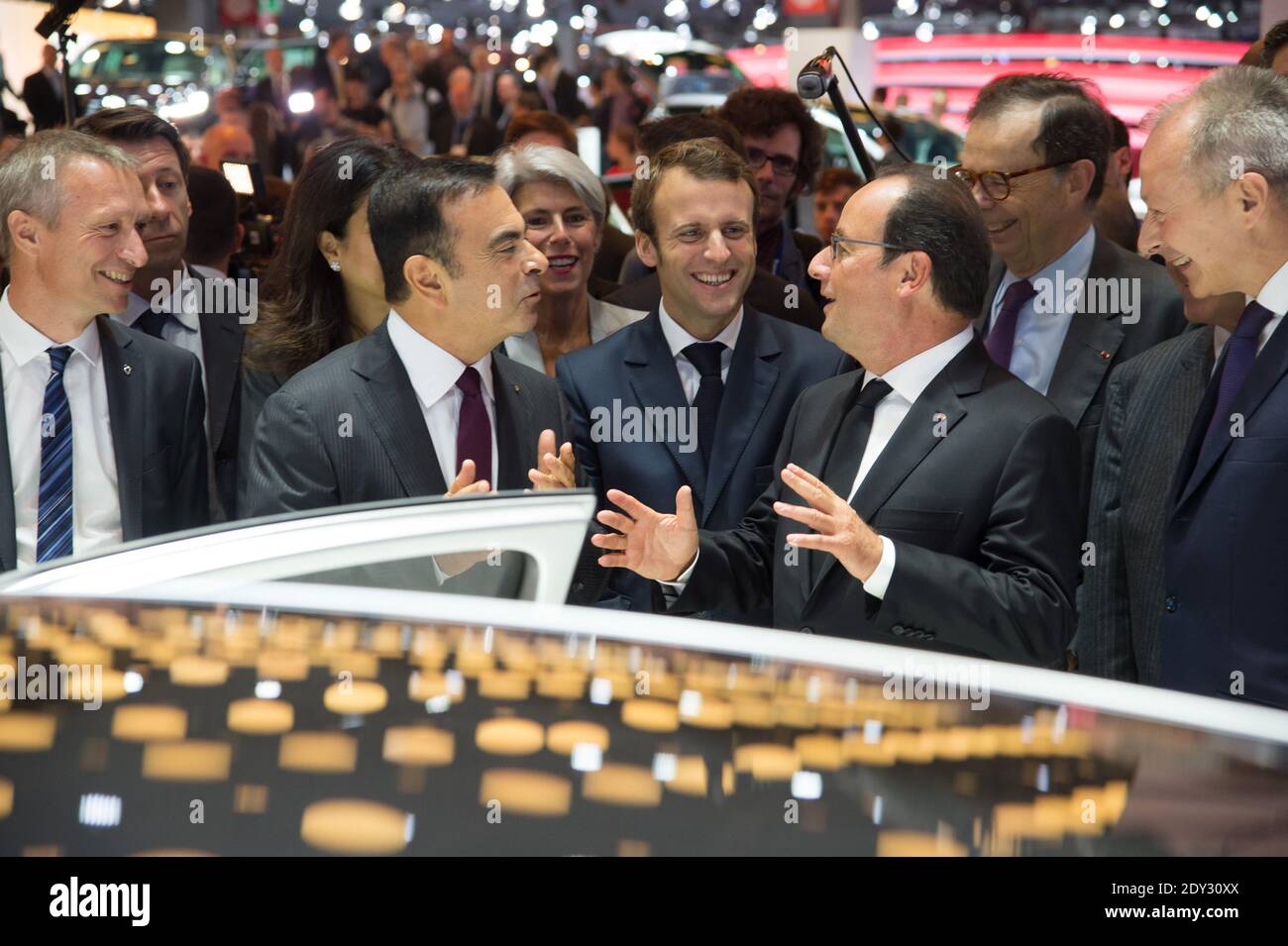 French President Francois Hollande (C) speaks as he tours the stand for ...