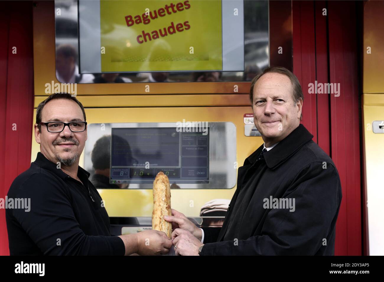 French baker Jean-Louis Hecht (L) poses with Philippe Goujon, the mayor ...