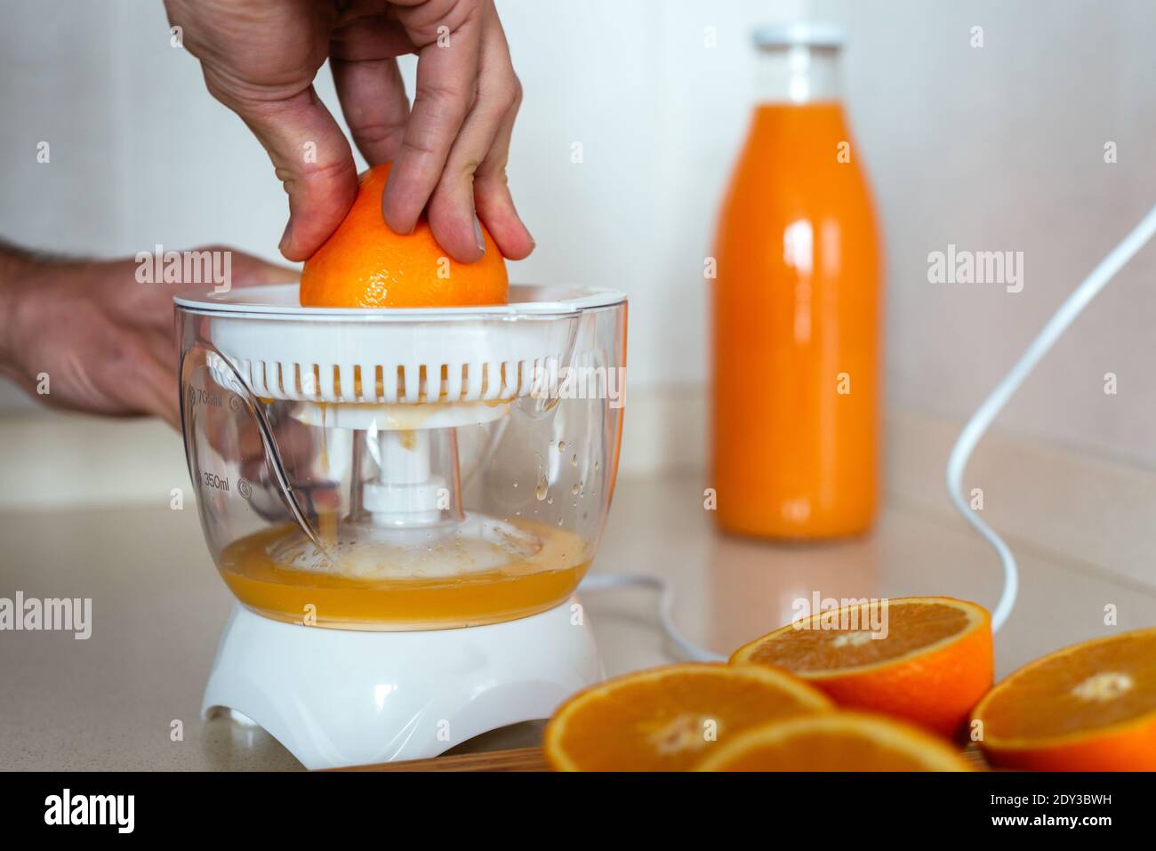 A closeup shot of squeezing orange juice Stock Photo - Alamy