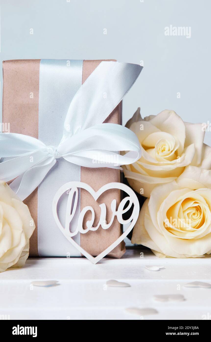 The word love in white letters on gift boxes with white ribbons and ...