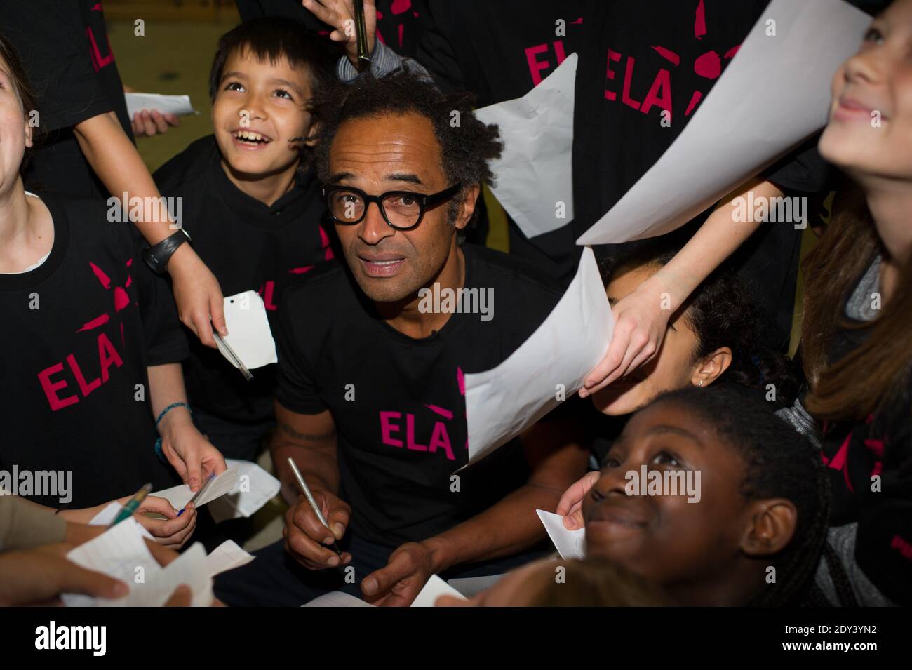 Yannick Noah dictates a text to pupils in a primary school of Paris, on ...