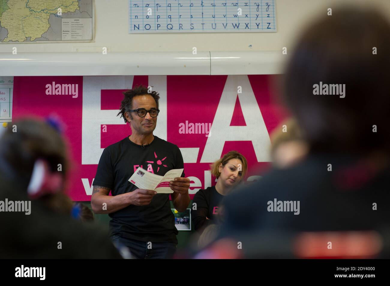 Yannick Noah dictates a text to pupils in a primary school of Paris, on ...