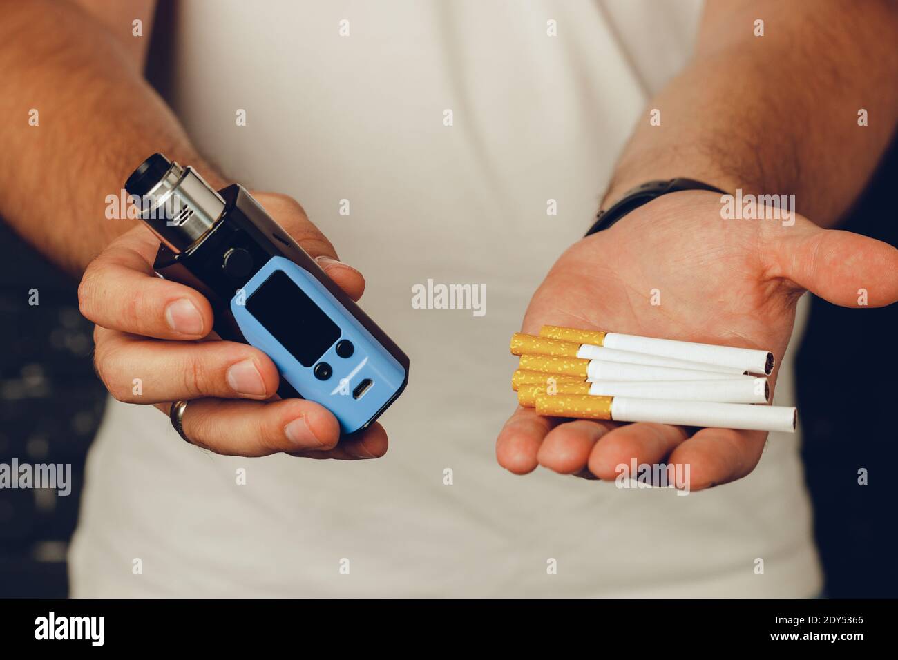 Male holding cigarettes and vape inhaler close up Stock Photo - Alamy