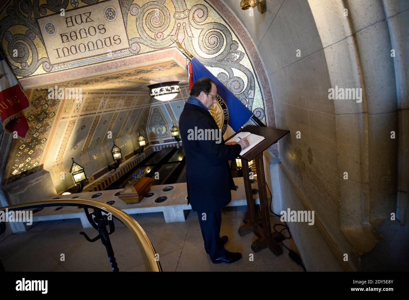 French President Francois Hollande signs a book of remembrance after ...