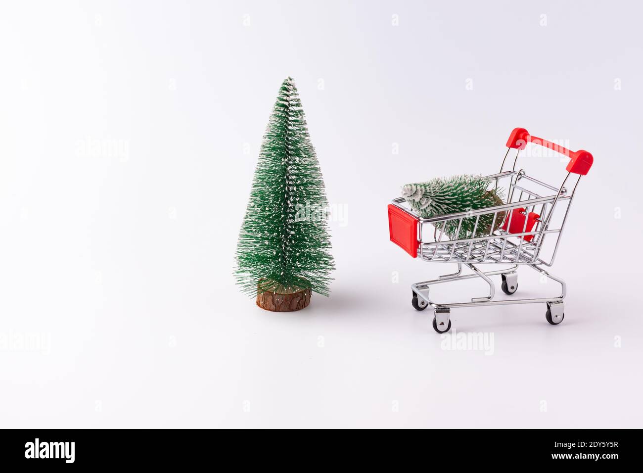 supermarket mini trolley with two Christmas trees Stock Photo - Alamy