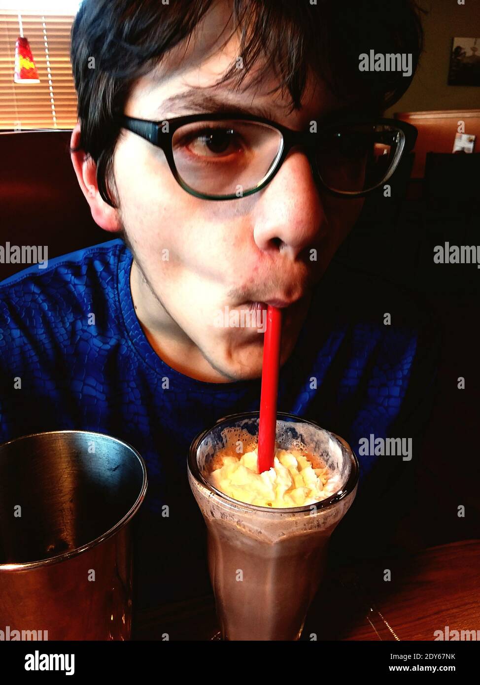 Boy in cafe drinking milkshake hi-res stock photography and images - Alamy