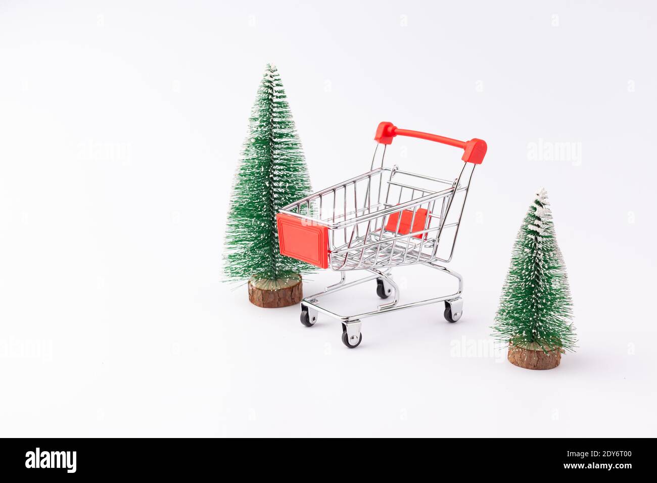 Two Christmas trees and a supermarket trolley Stock Photo - Alamy