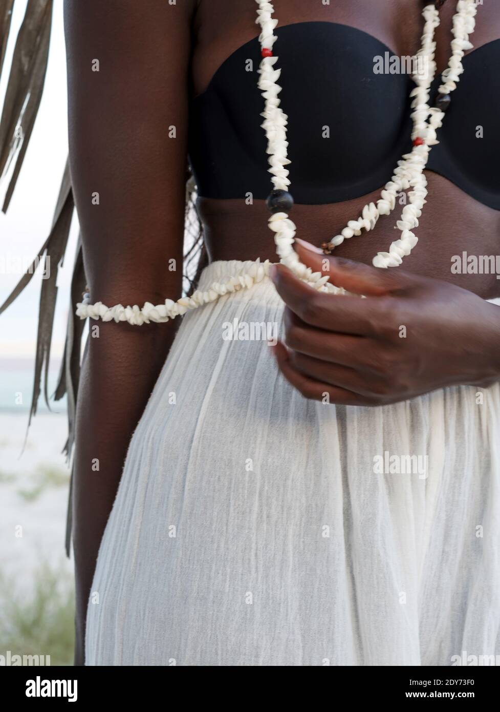 Woman wearing shell necklace hi-res stock photography and images - Alamy