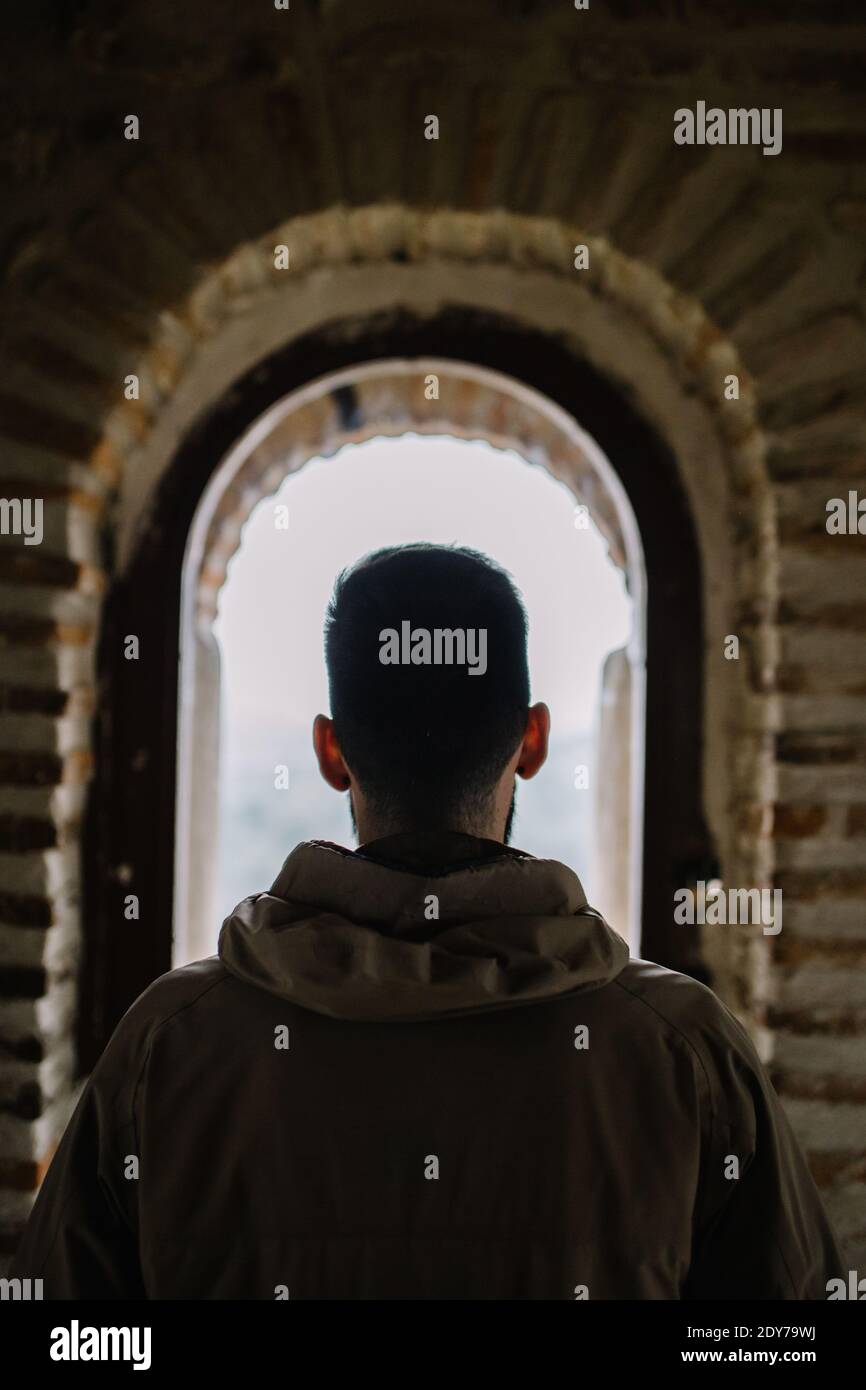 Man on his back looking out the window Stock Photo - Alamy