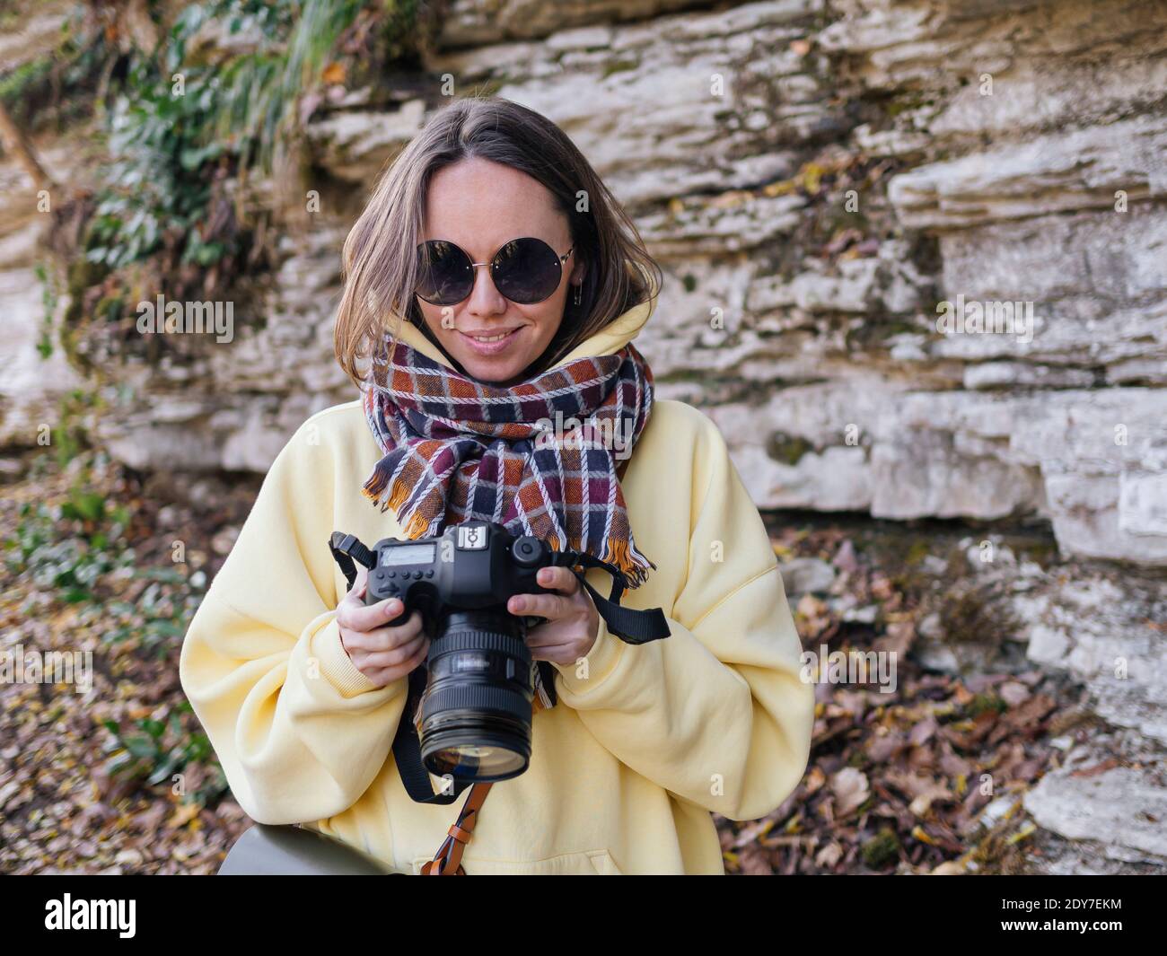 Young woman with camera in mountain Stock Photo - Alamy