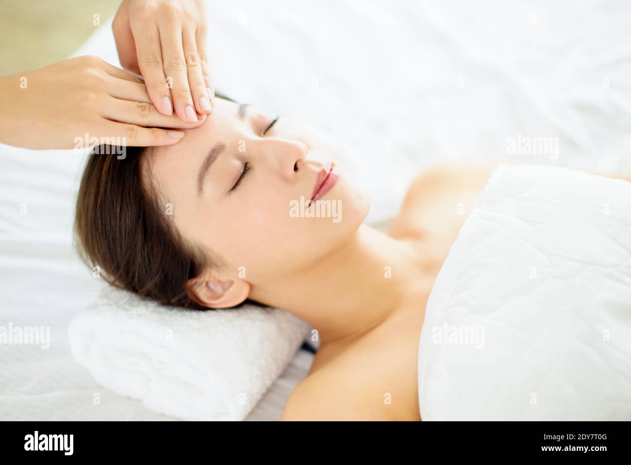 relaxed Young woman enjoy massage in spa salon Stock Photo - Alamy