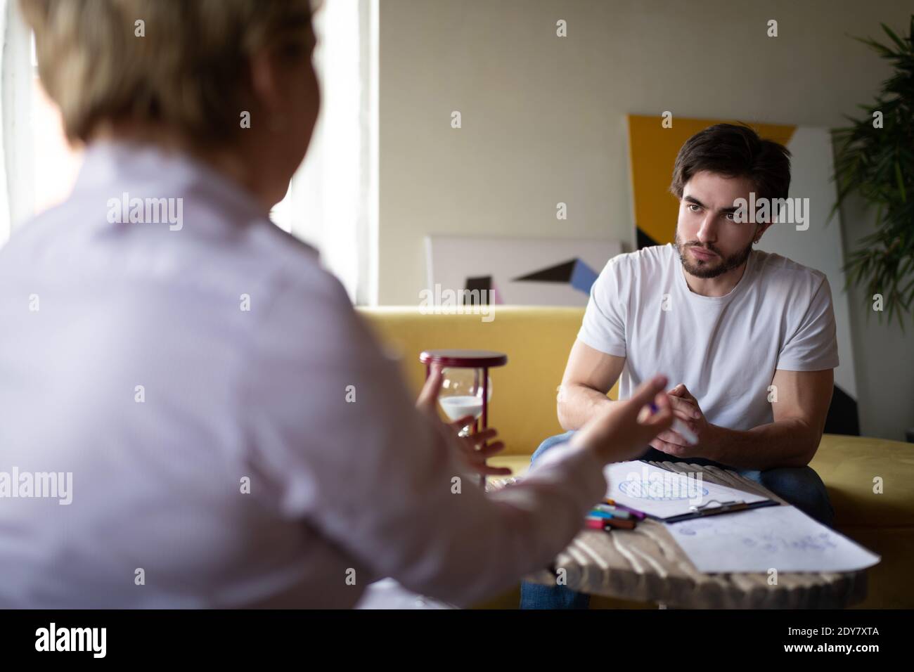 Blurred female psychologist gesticulating and discussing test results ...