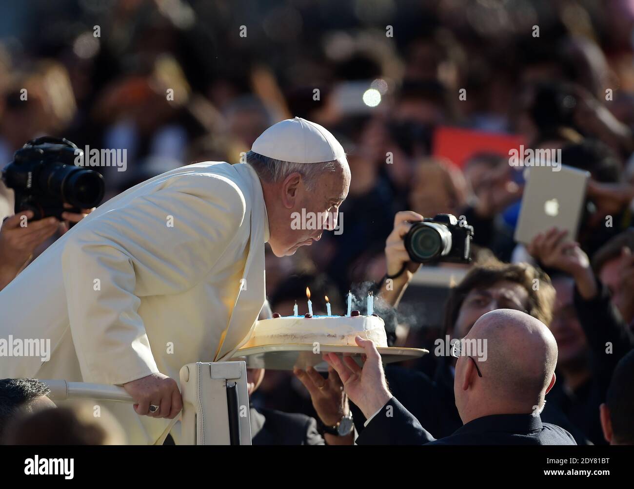 Pope Francis blows candles on a birthday cake on the occasion of his ...