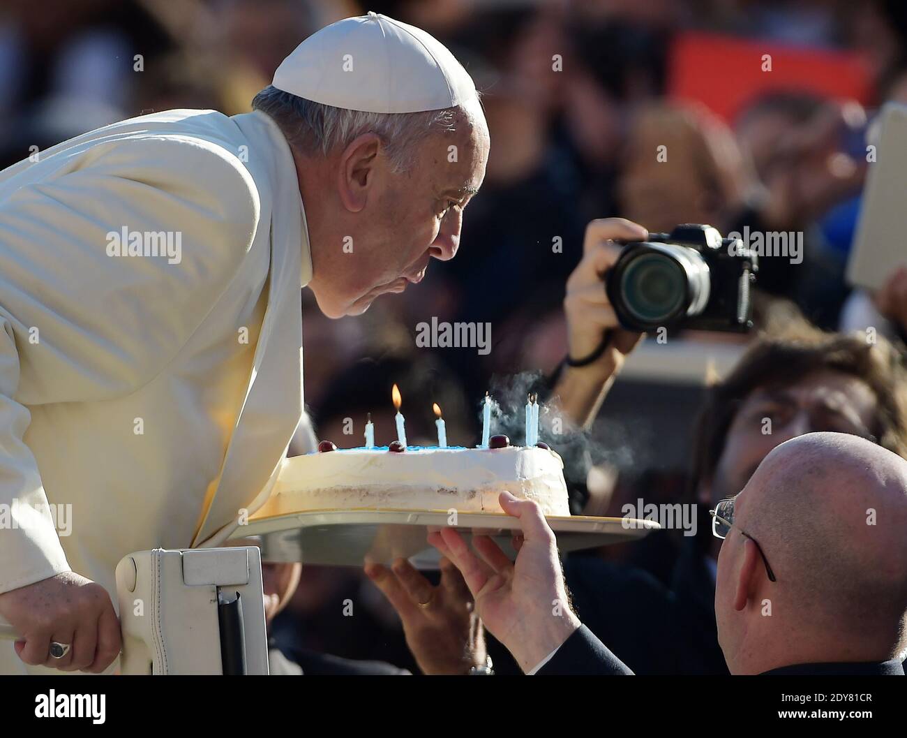 Pope Francis blows candles on a birthday cake on the occasion of his ...