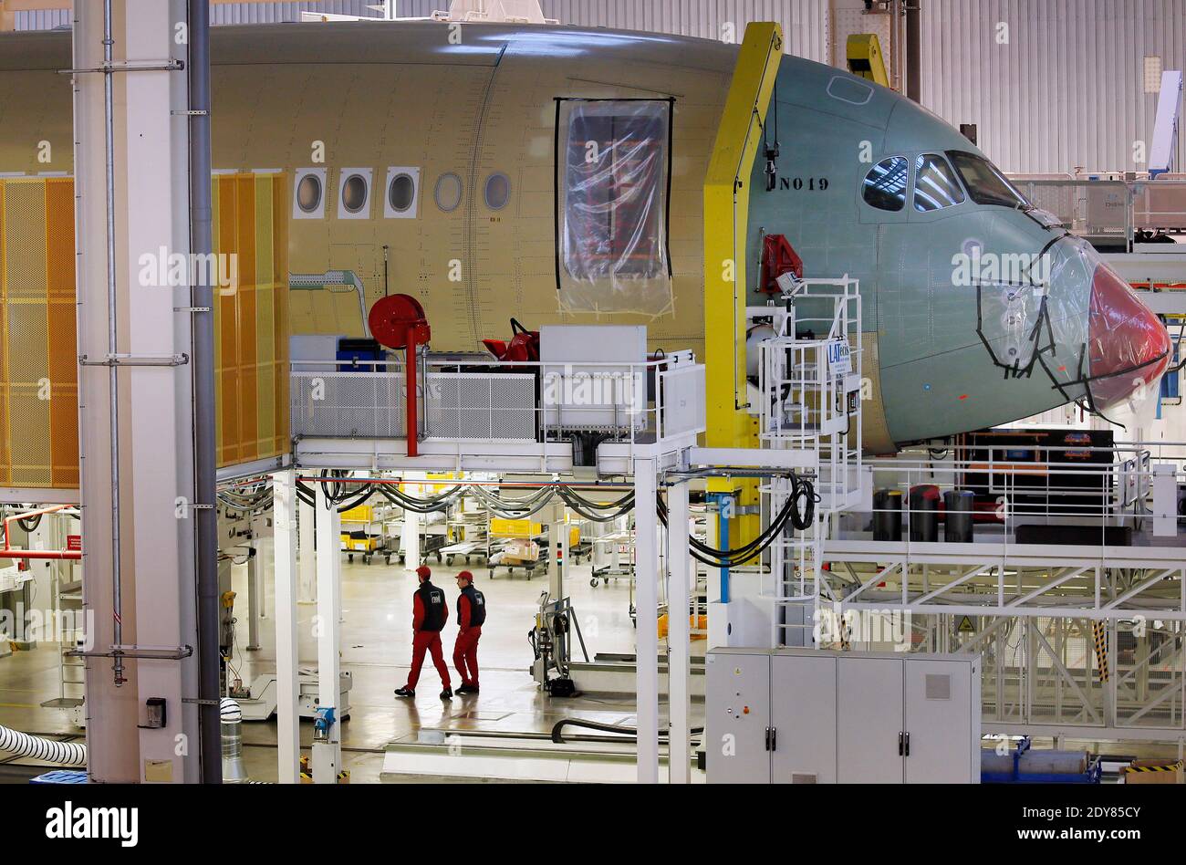Technicians work on the assembly line of an Airbus A350 at the Airbus ...