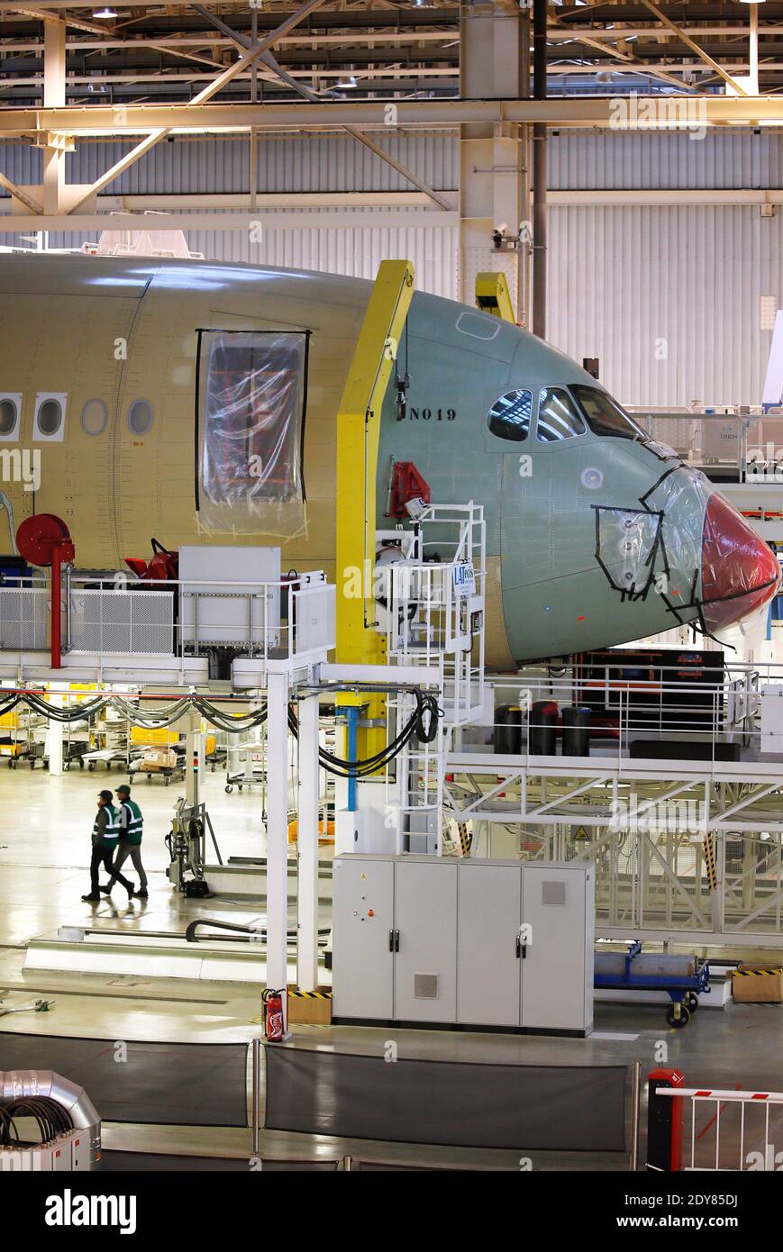 Technicians work on the assembly line of an Airbus A350 at the Airbus ...