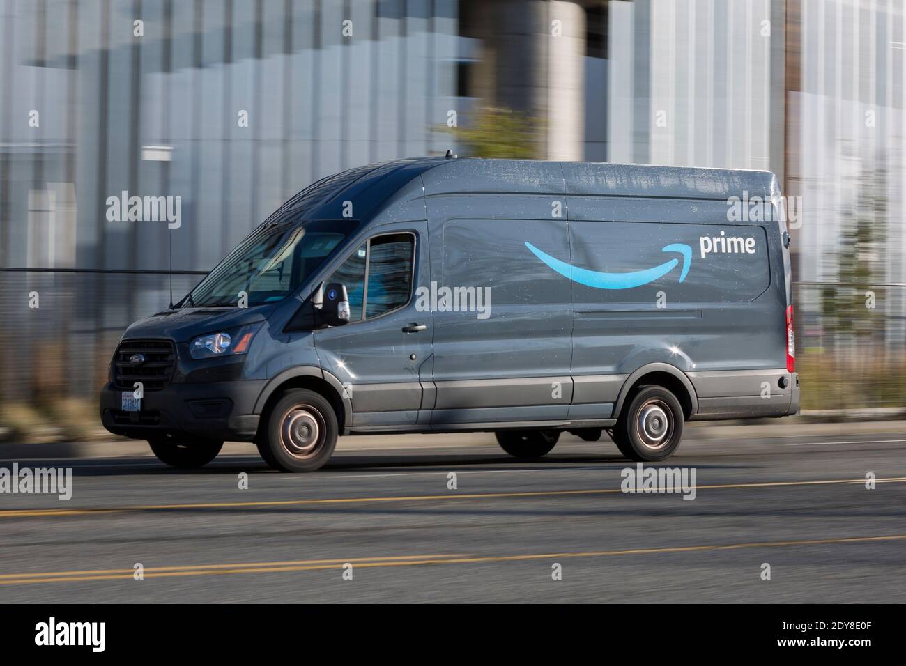 A delivery van leaves Amazon’s fulfillment center in South Seattle on ...