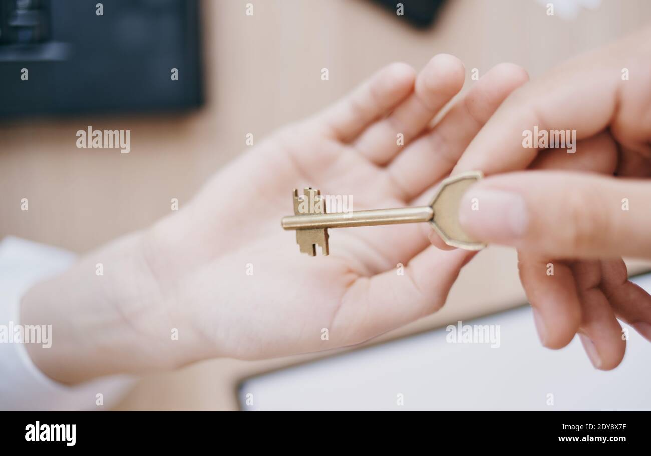 handing the key from hand to hand in the office business finance work ...
