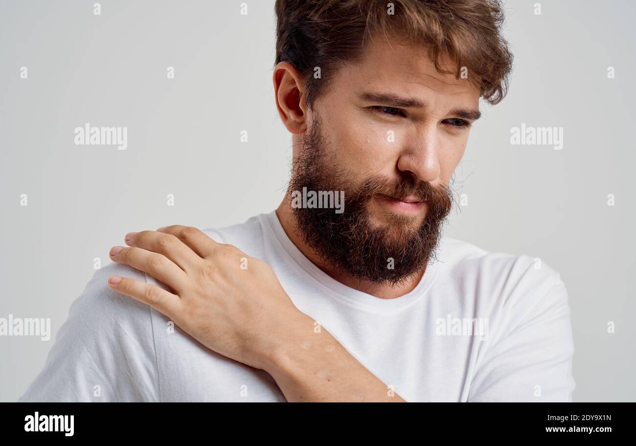 bearded man touching shoulder with hand pain dislocation Stock Photo ...