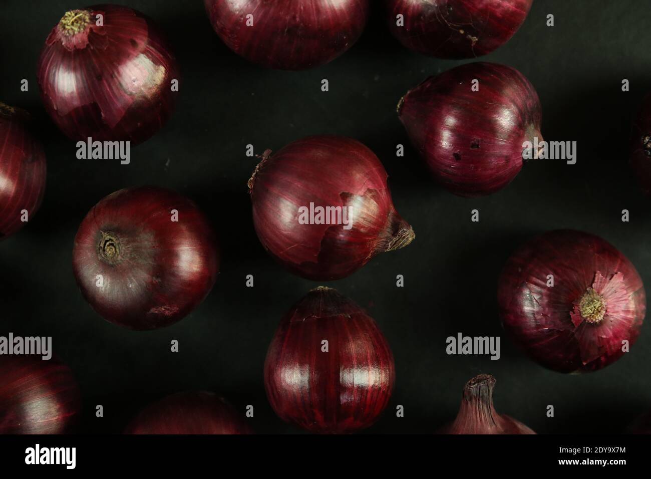 sweet red onions on background Stock Photo - Alamy
