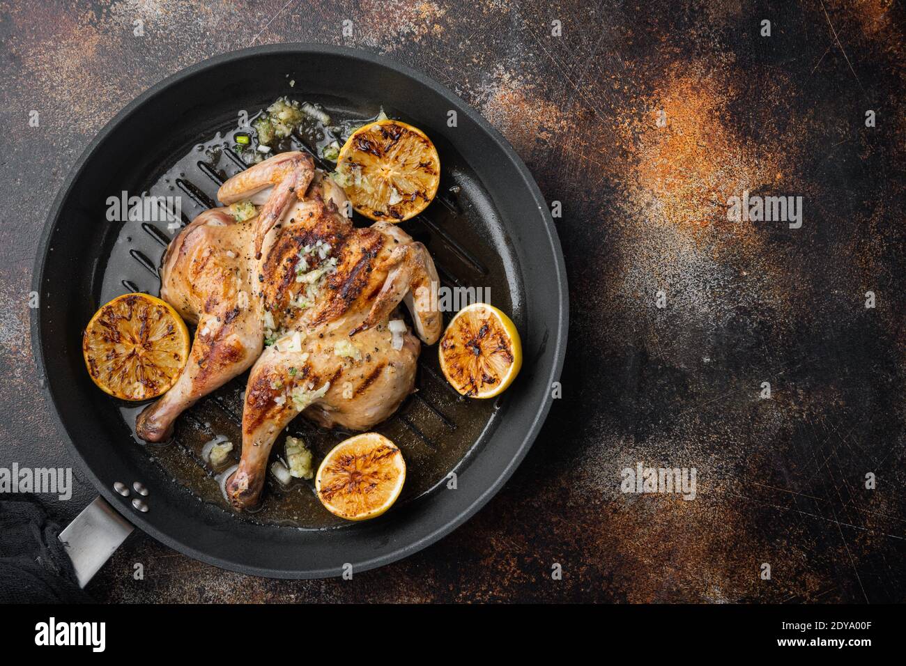Roasted spatchcock poussin meal, on old rustic background, top view ...