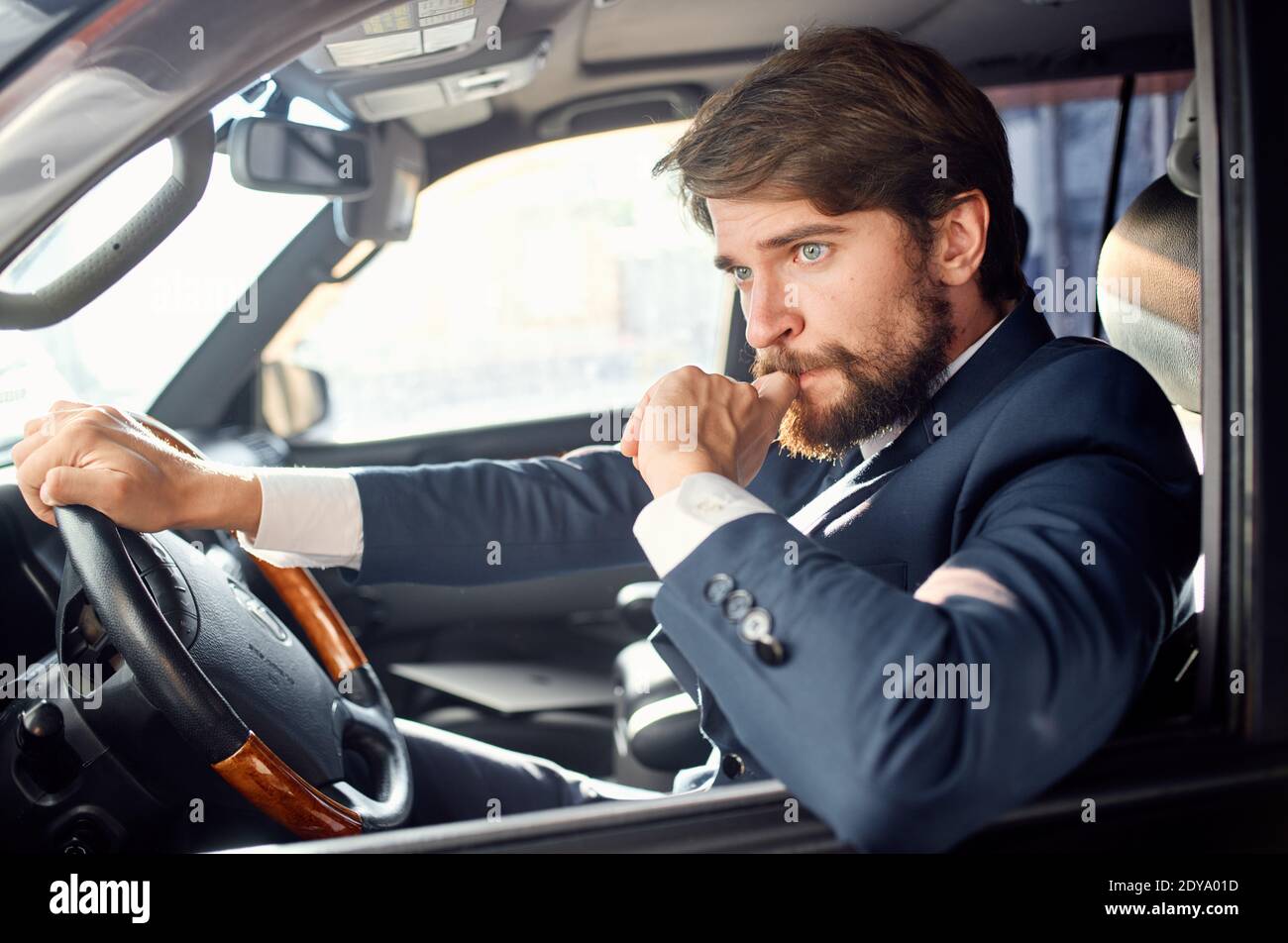 business man in a suit driving a car trip emotions official Stock Photo ...