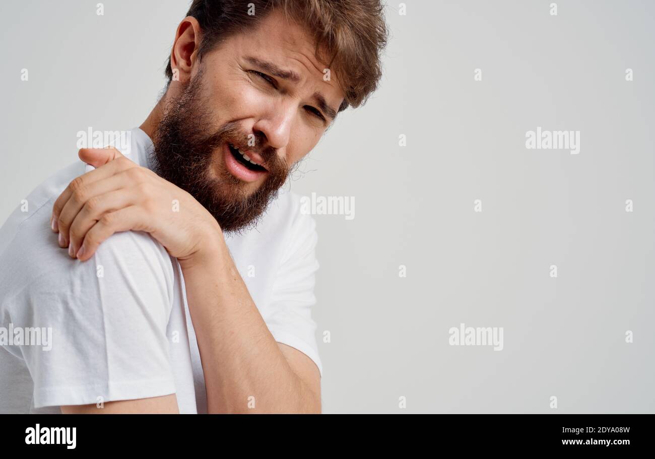 bearded man touching shoulder with hand pain dislocation Stock Photo ...