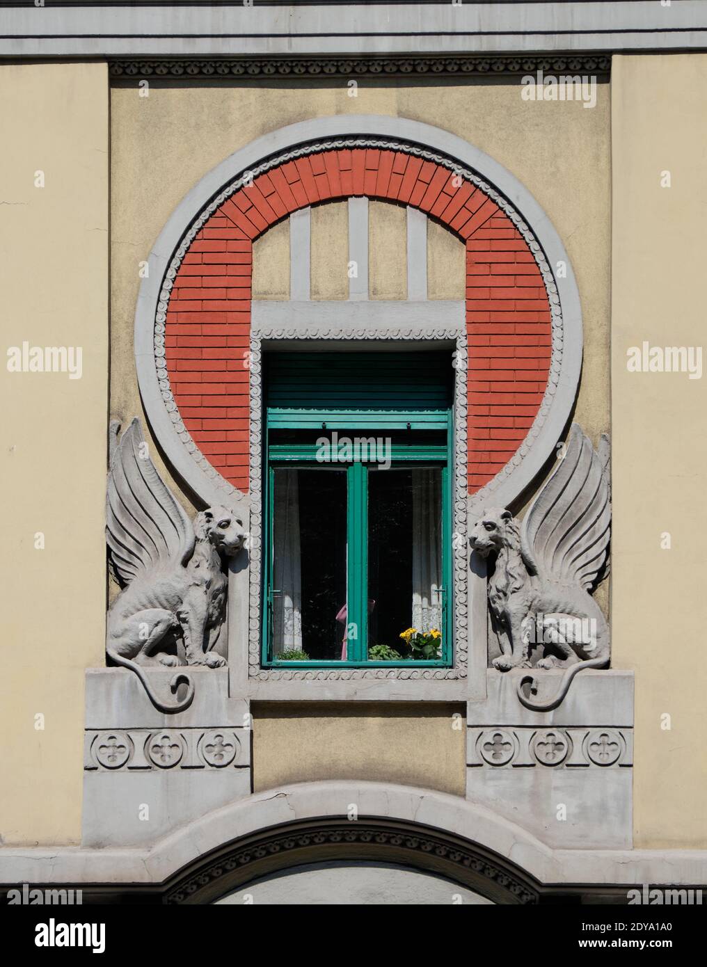 Window with decorative architectural frame featuring winged animals ...