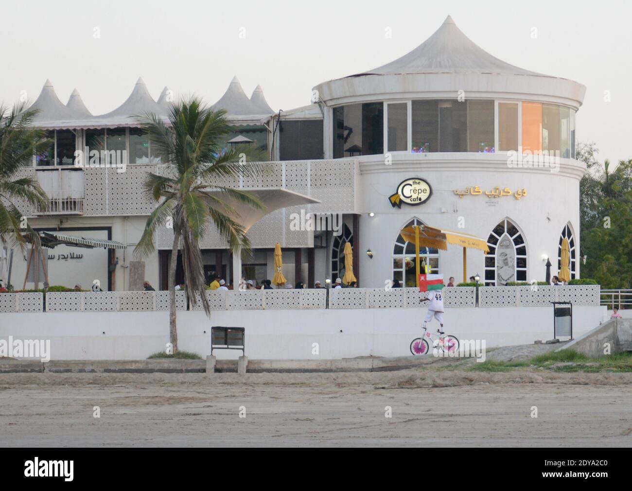An Omani cyclist from the Omani cycle club holding the flag of Oman ...