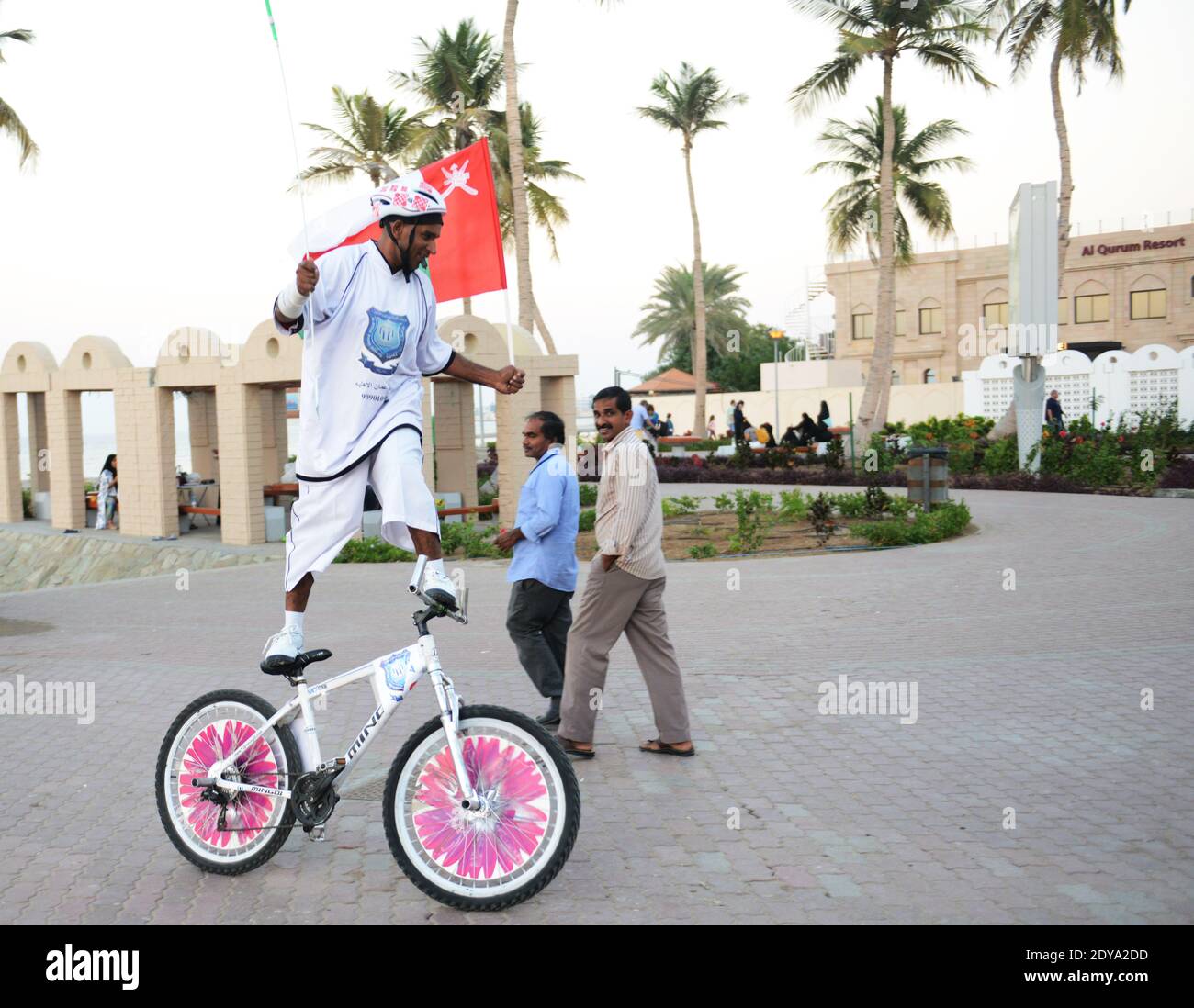 An Omani cyclist from the Omani cycle club holding the flag of Oman ...