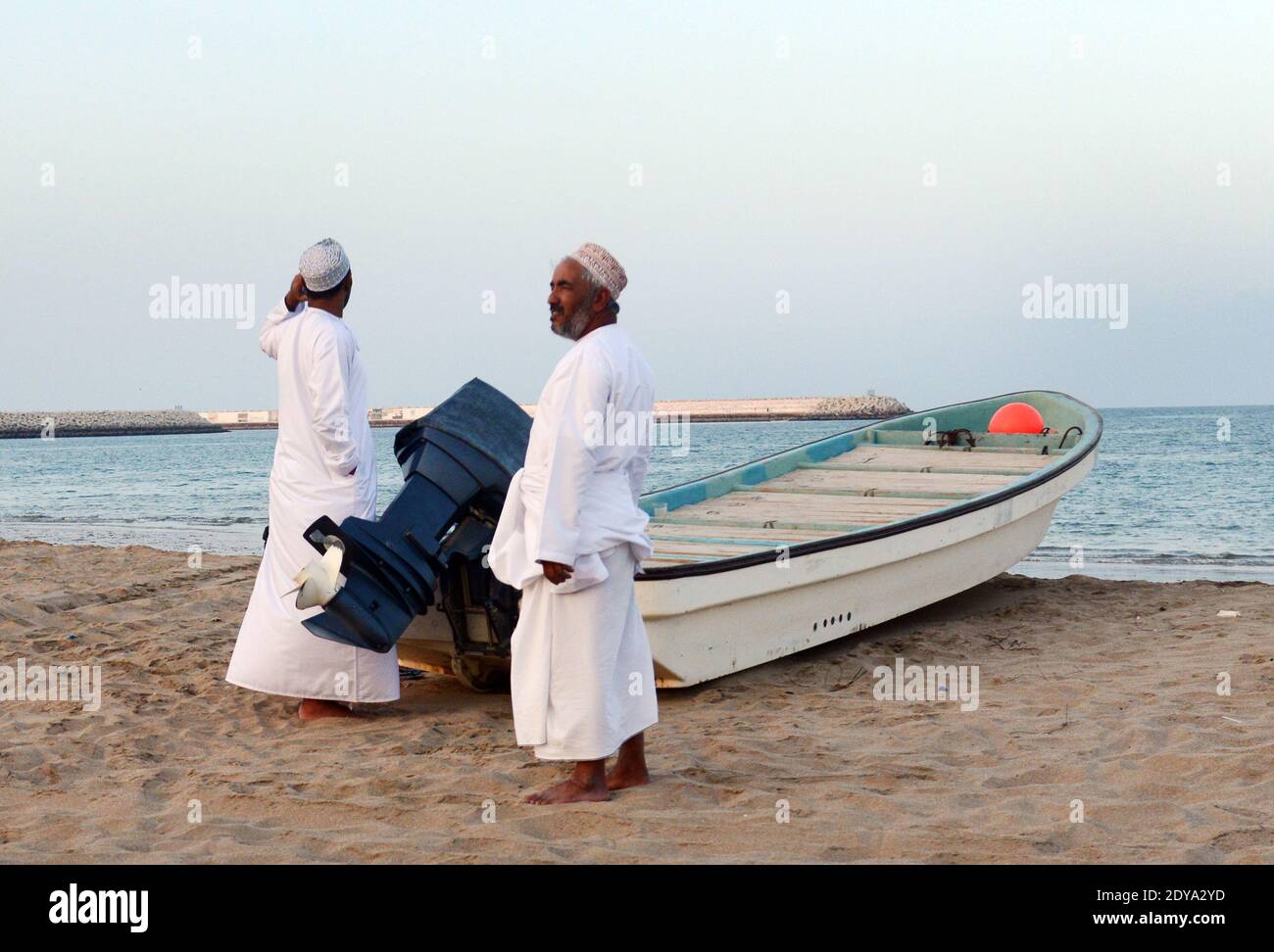 Omani men standing by their fishing boat in Sur, Oman Stock Photo - Alamy