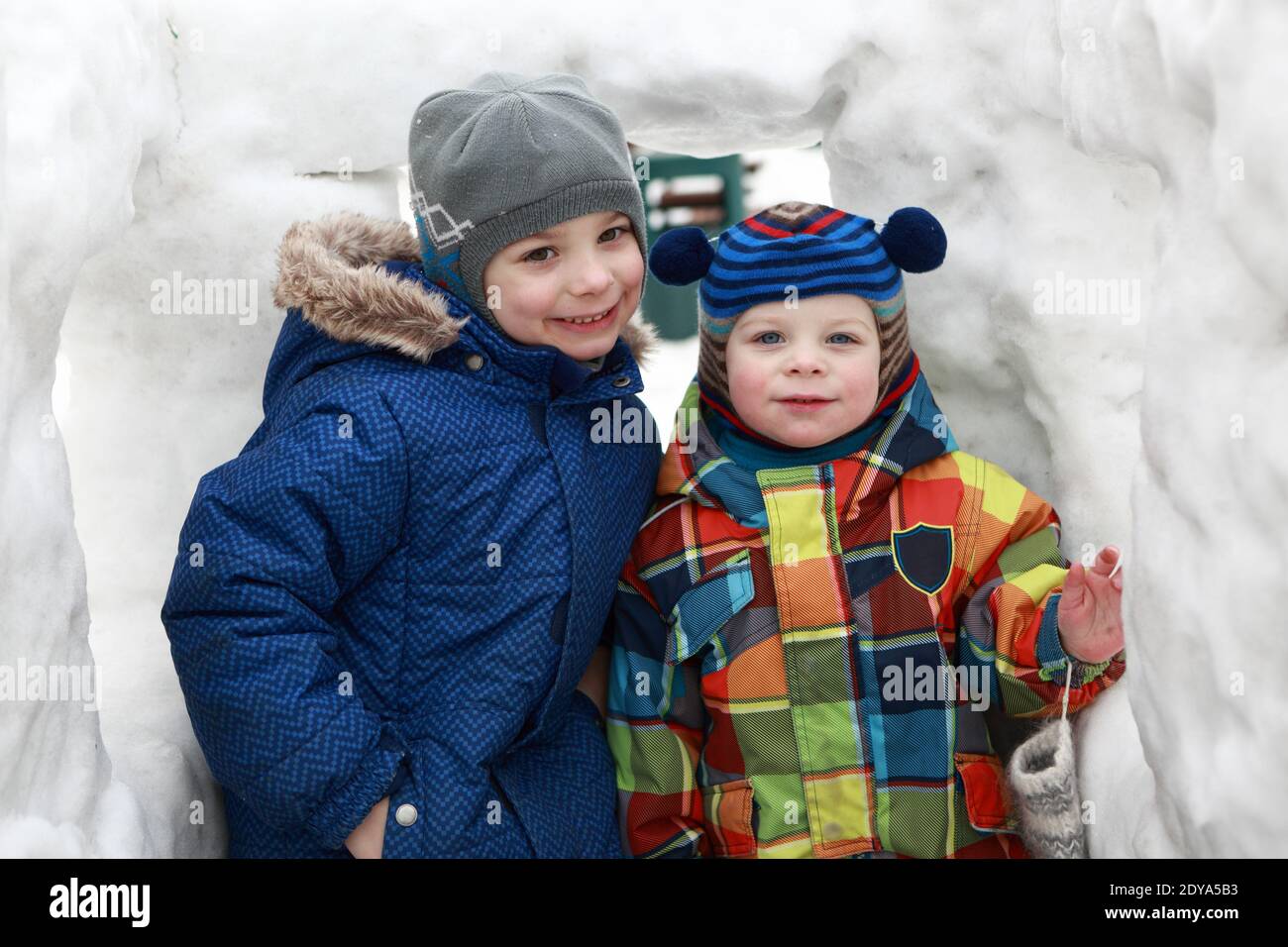 Portrait of two brothers in snow house Stock Photo - Alamy
