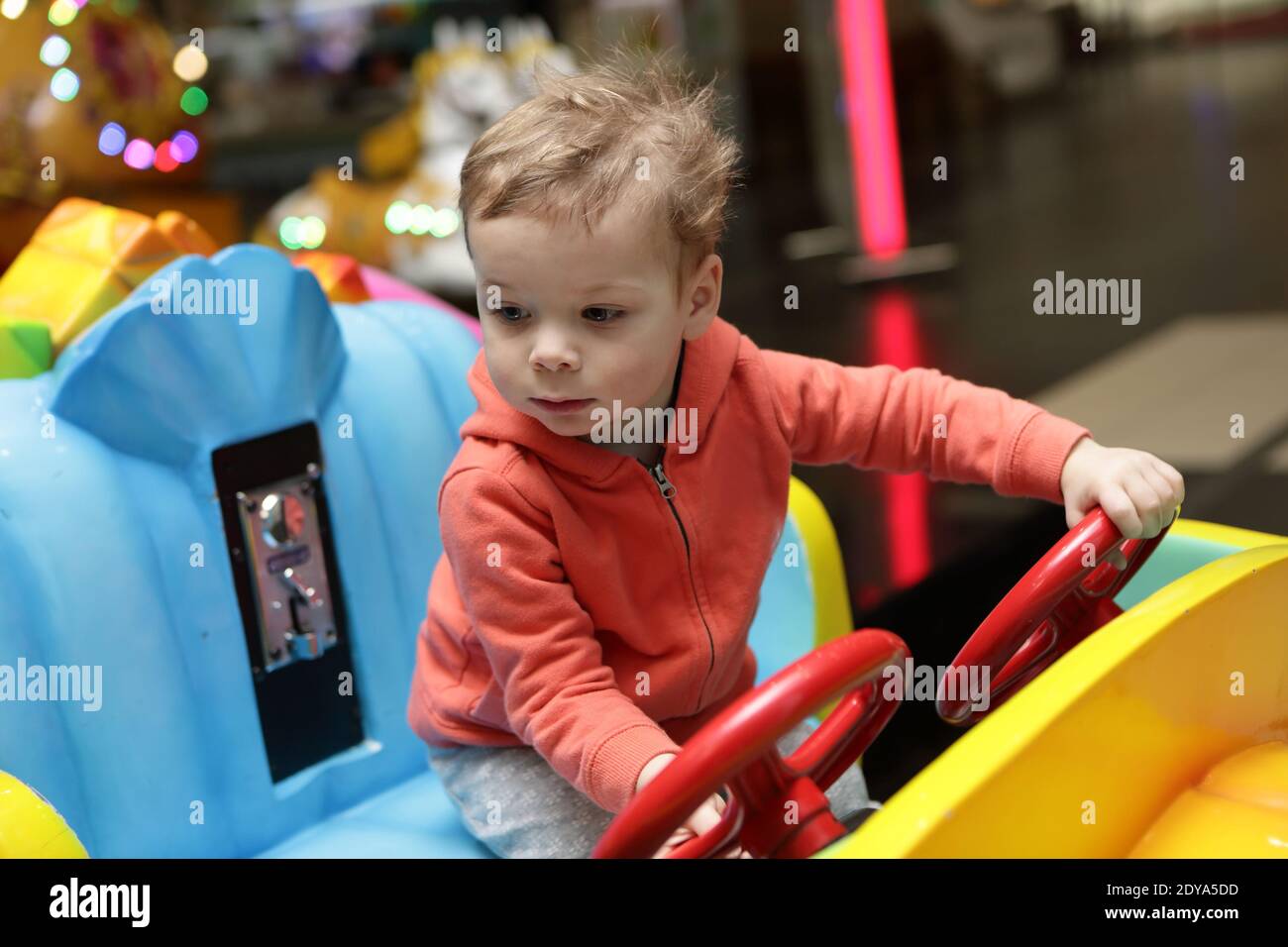 Child driving toy car in amusement park Stock Photo - Alamy