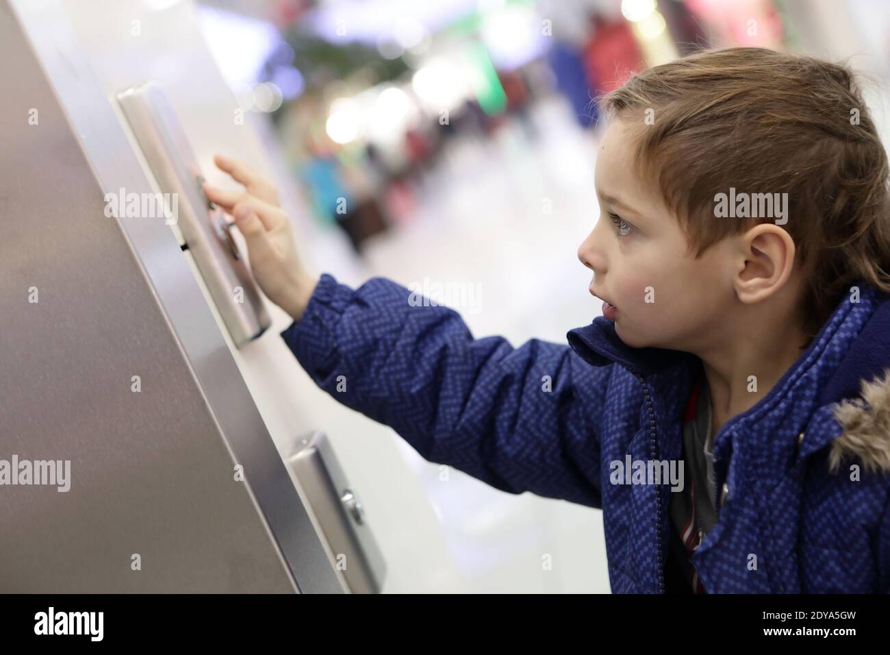 Child pushing elevator button in a hotel Stock Photo - Alamy