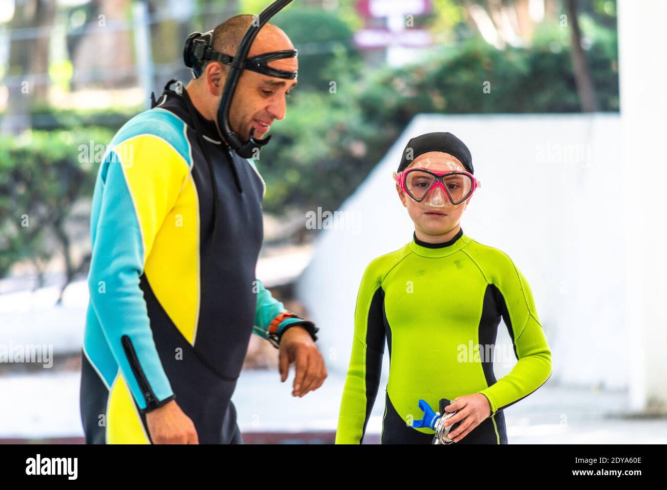 a master diver giving instructions to his young students for the ...