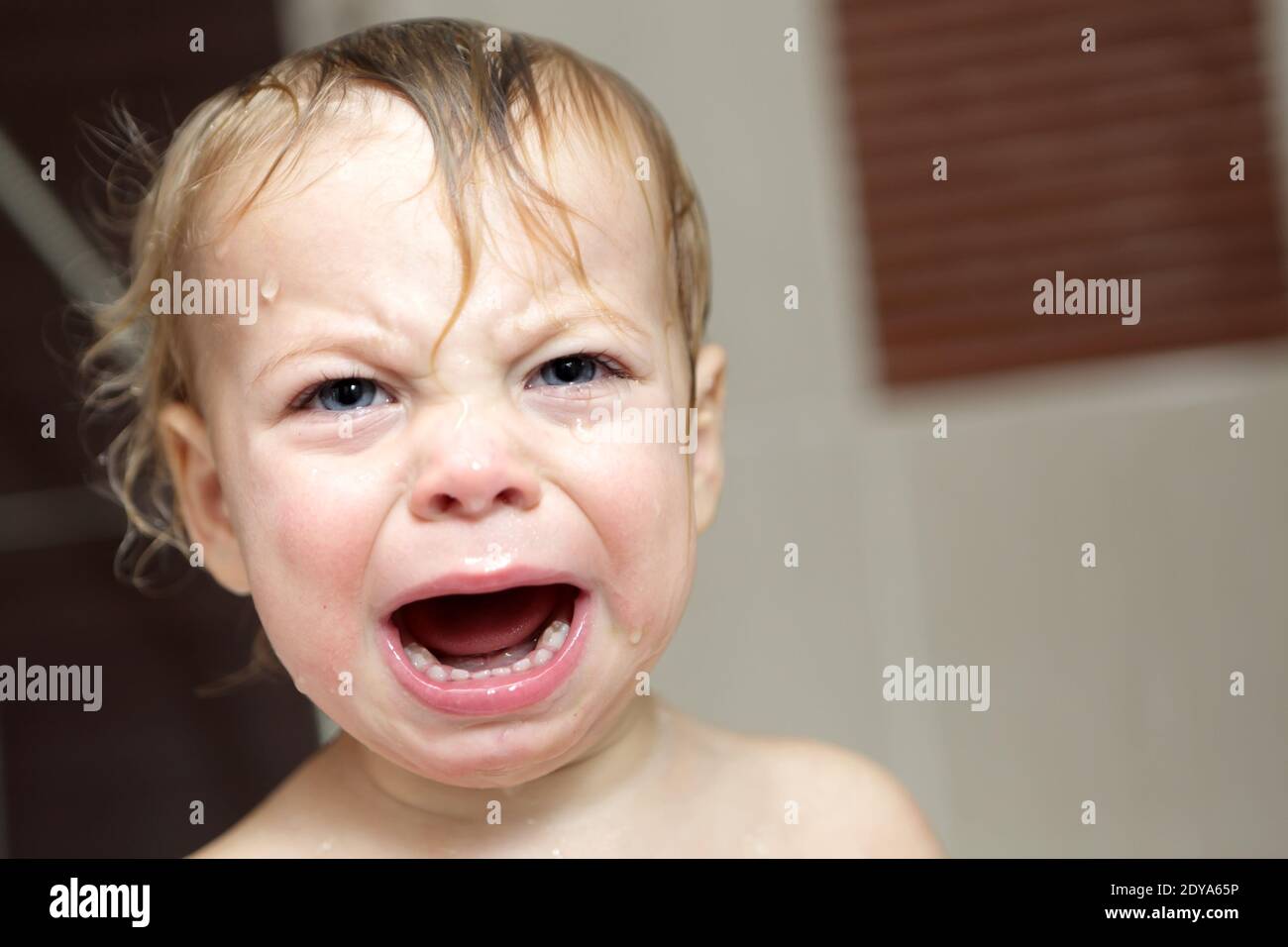 Child crying in the bath at home Stock Photo - Alamy
