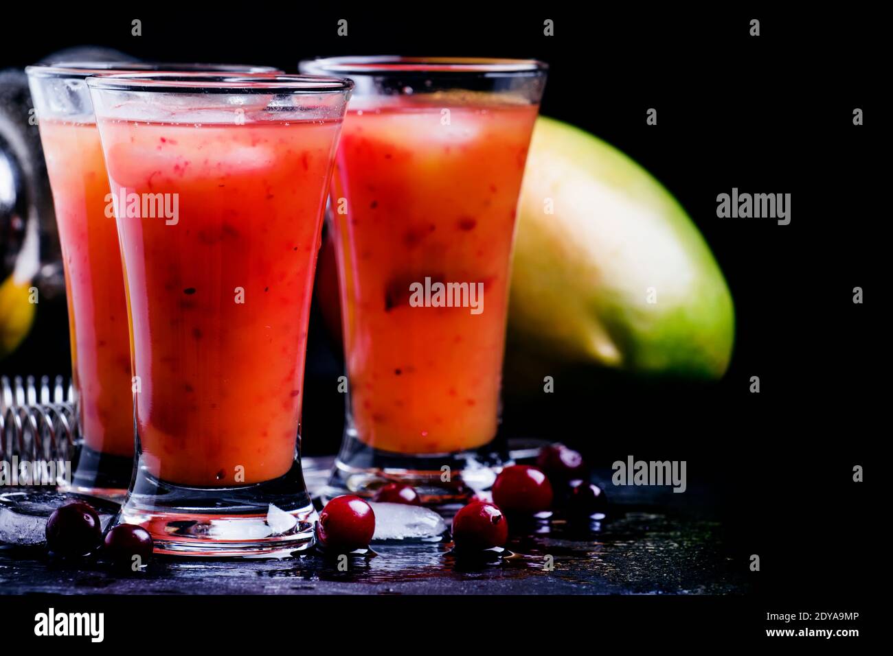 Alcoholic cocktail mango and cranberry liqueur with syrup, juice and ...