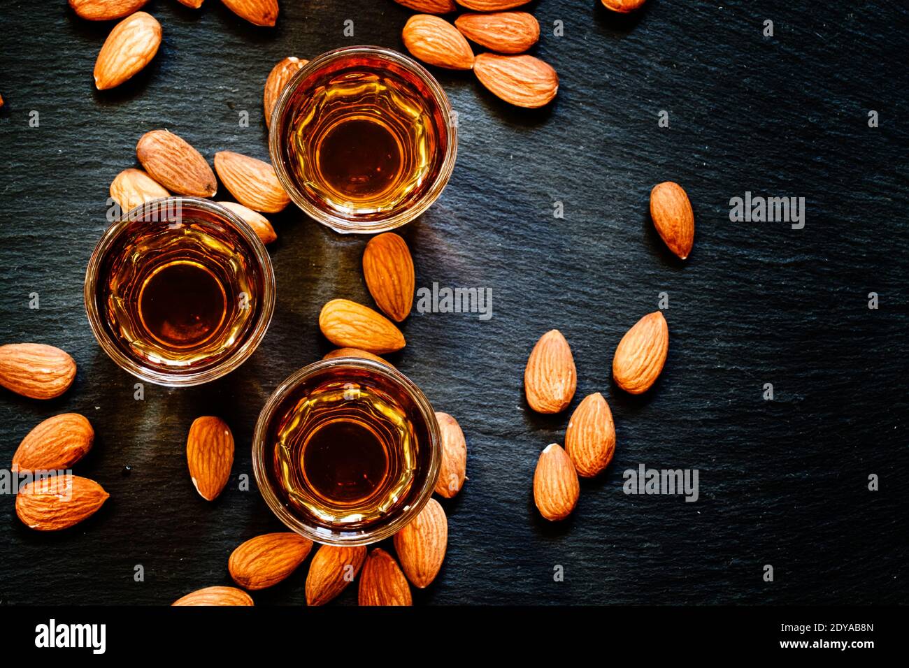 Amaretto almond liqueur with a dark background, top view Stock Photo ...