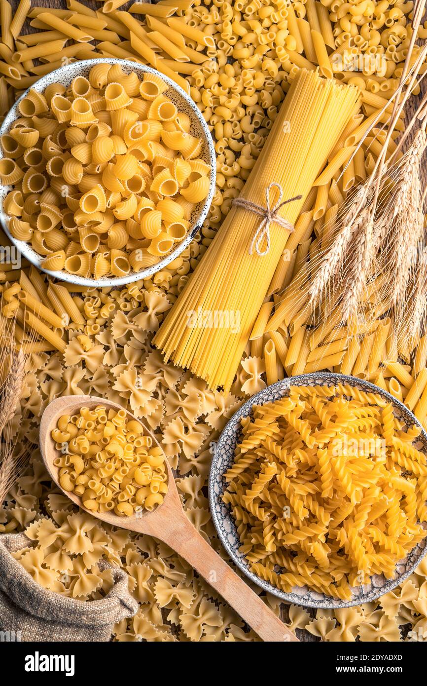A large assortment of pasta on the table. Top view, vertical ...