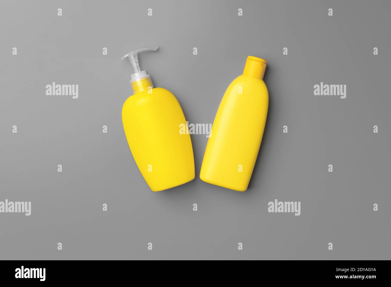 Yellow liquid detergents containers on gray background Stock Photo - Alamy