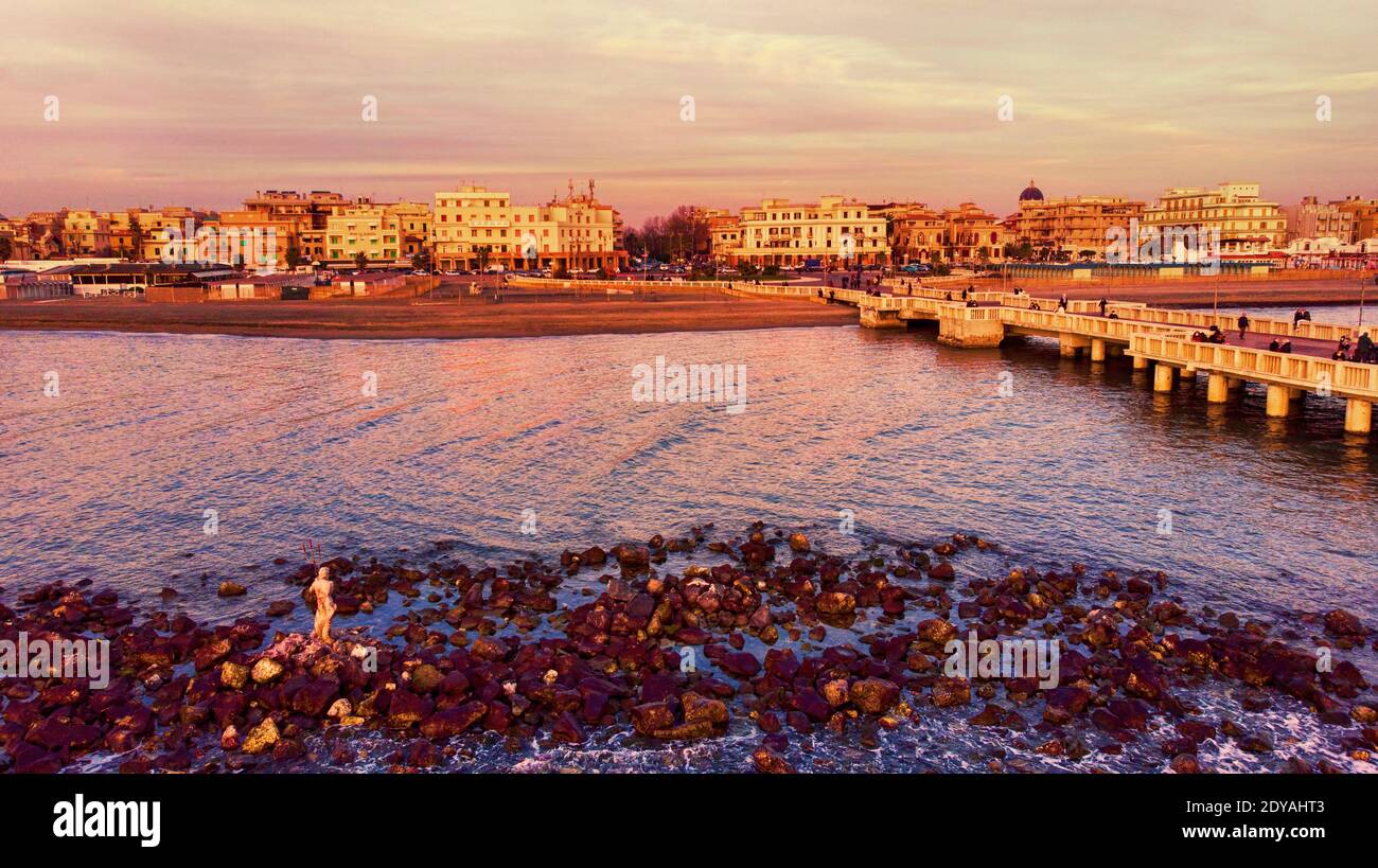 Sunset Rome aerial view at Ostia Lido beach from sea over cliff and ...