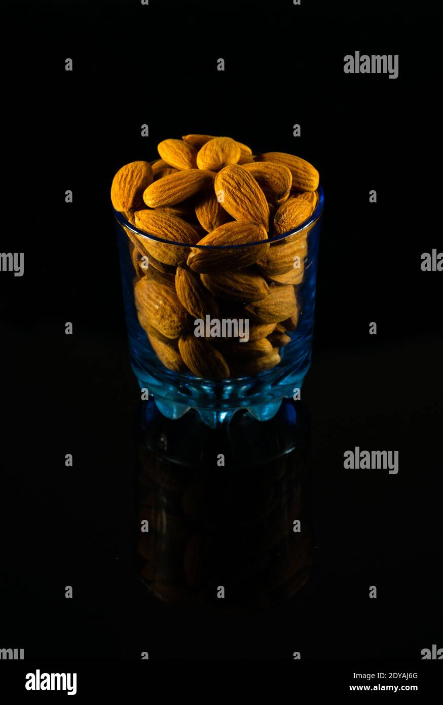 Protein-rich Raw Badam stacked in a glass on a dark table Stock Photo ...