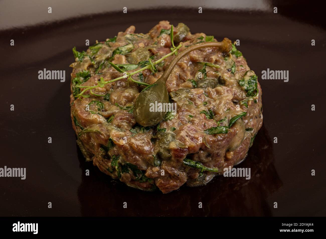 Raw beef tartar snack with capers Stock Photo - Alamy