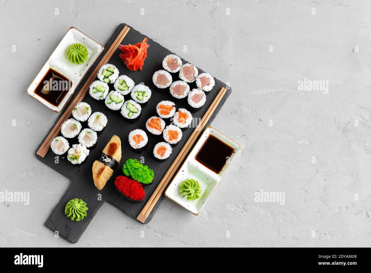Maki sushi set served on black stone tray Stock Photo - Alamy