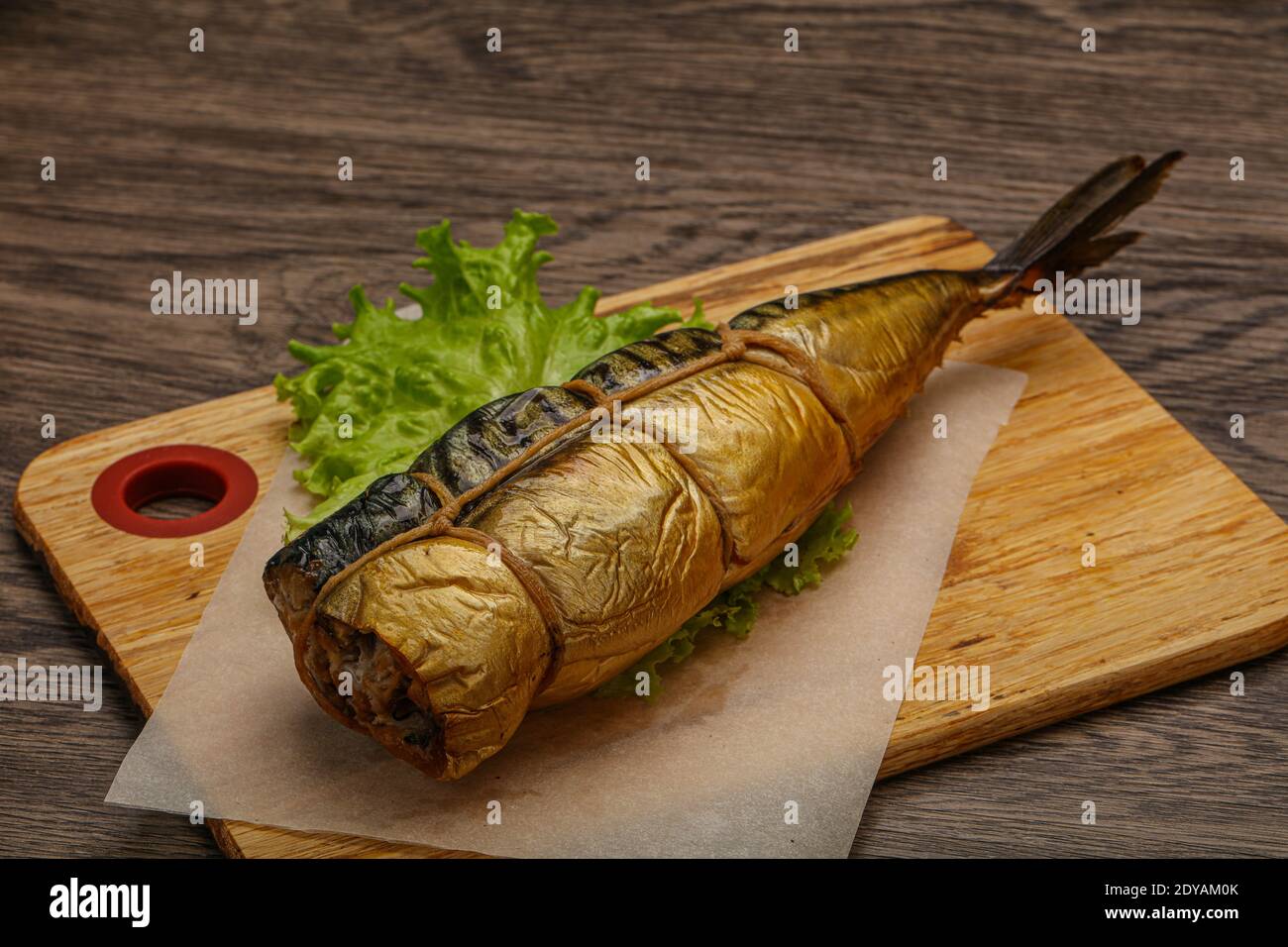 Smoked tasty mackerel fish snack over board Stock Photo - Alamy